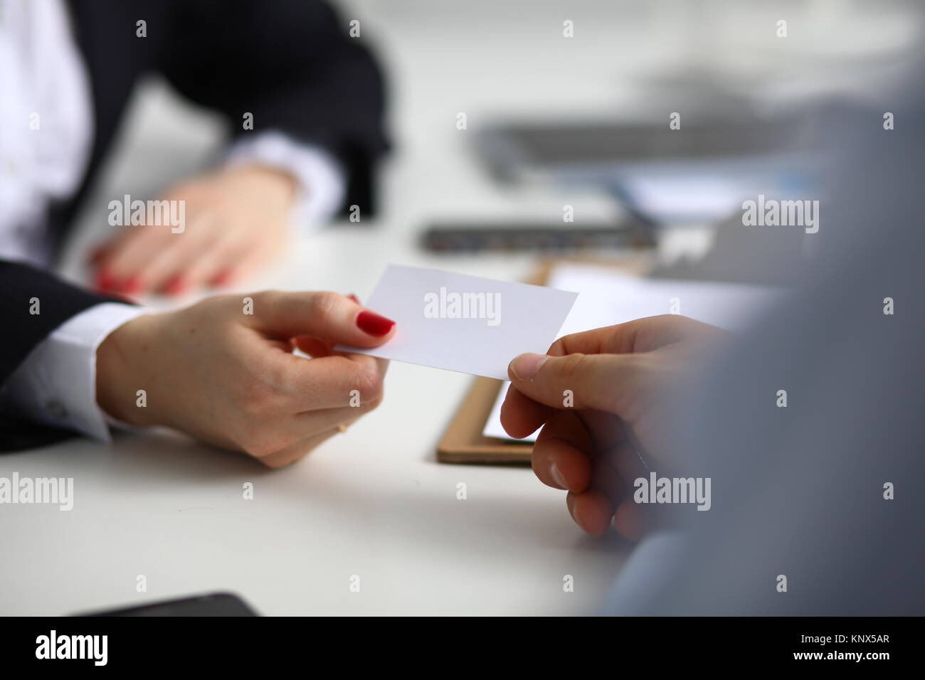 Woman hand giving business card in office Stock Photo - Alamy