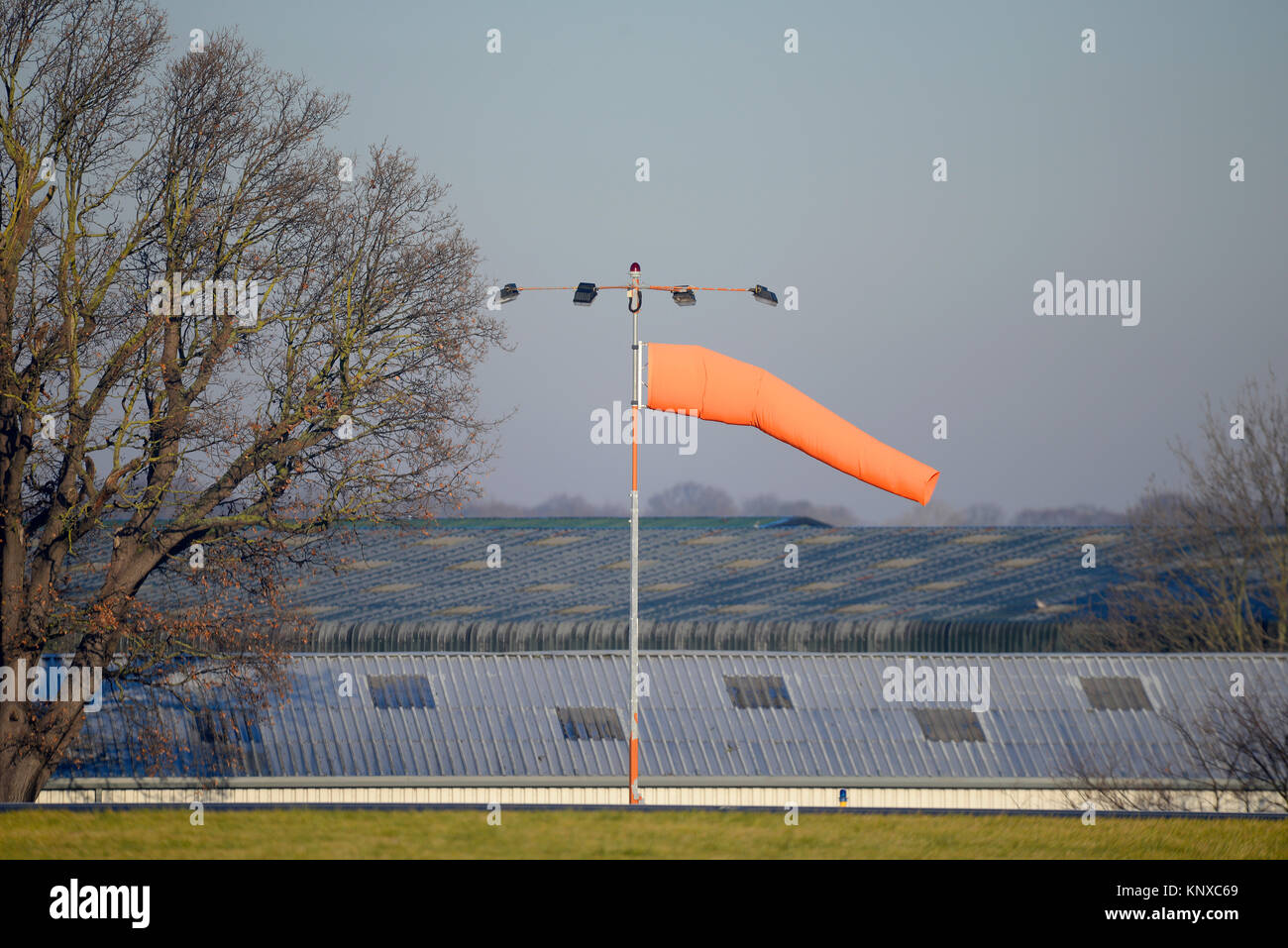 Wind sock in strong wind at London Southend Airport. With lights Stock ...