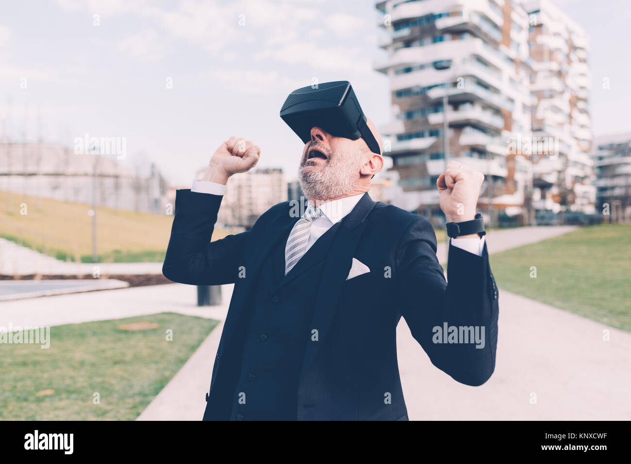 Middle age business man using smart watch and 3D viewer - futuristic ...