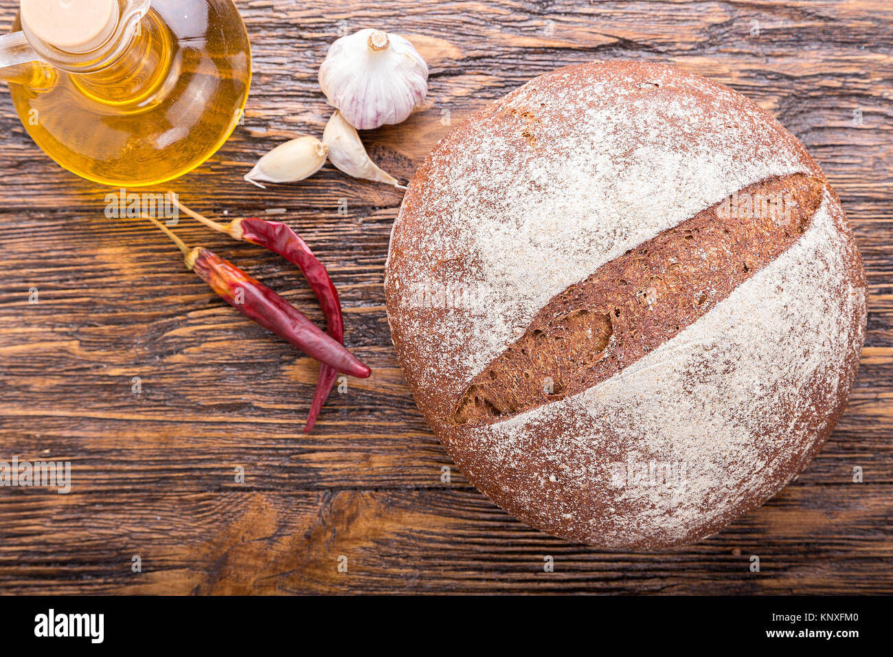 whole fresh loaf of round rye bread with a crispy crust, standing ...