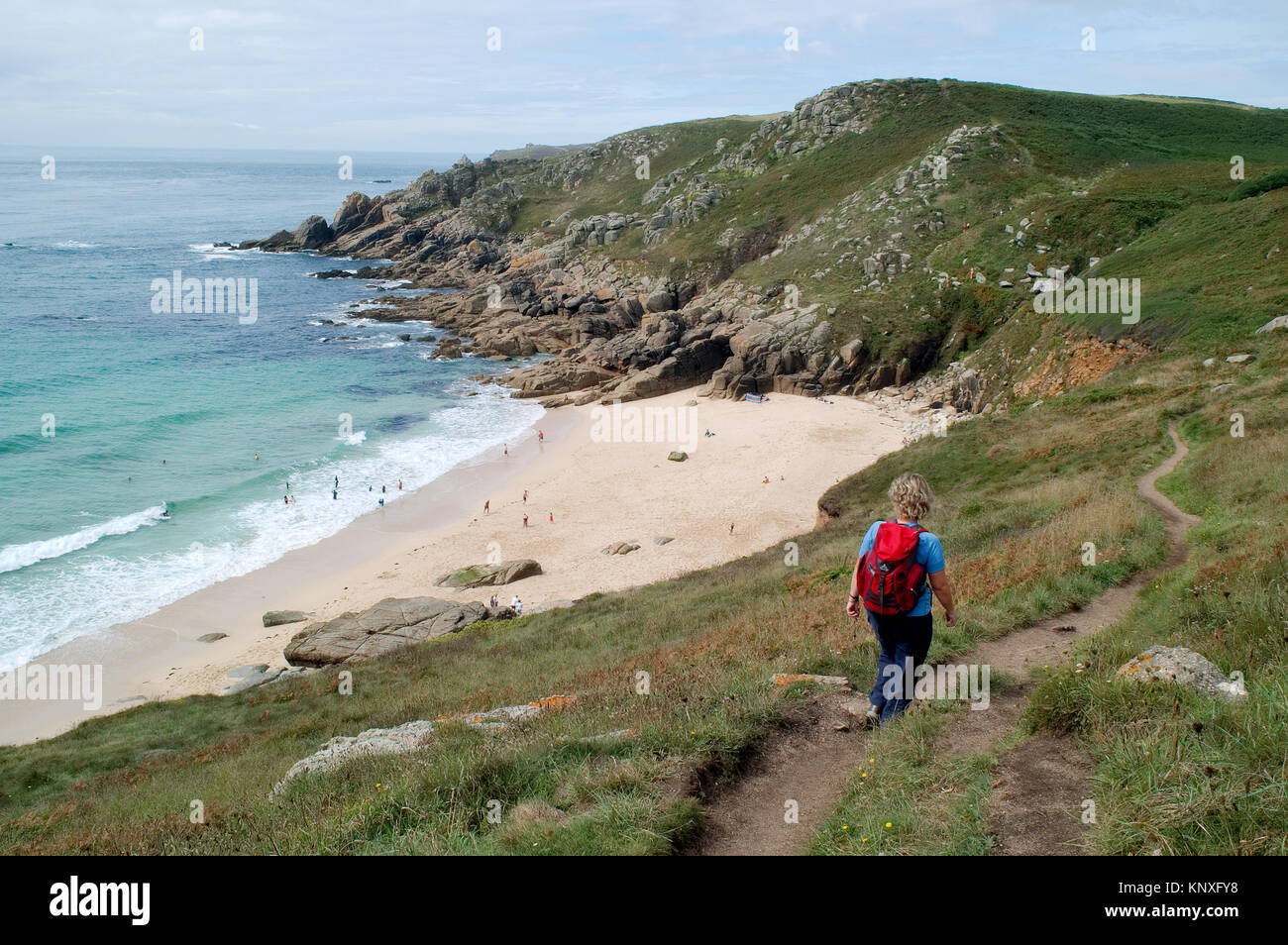 Porth Chapel beach, St. Levan, Cornwall. Female hiker on the South West ...