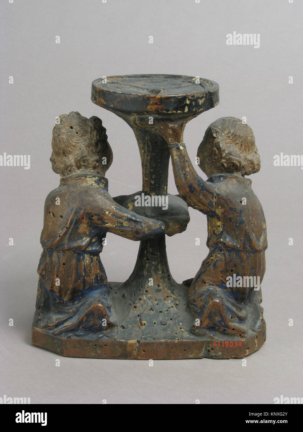 This French 14th-century wooden candlestick held by two angels is ...
