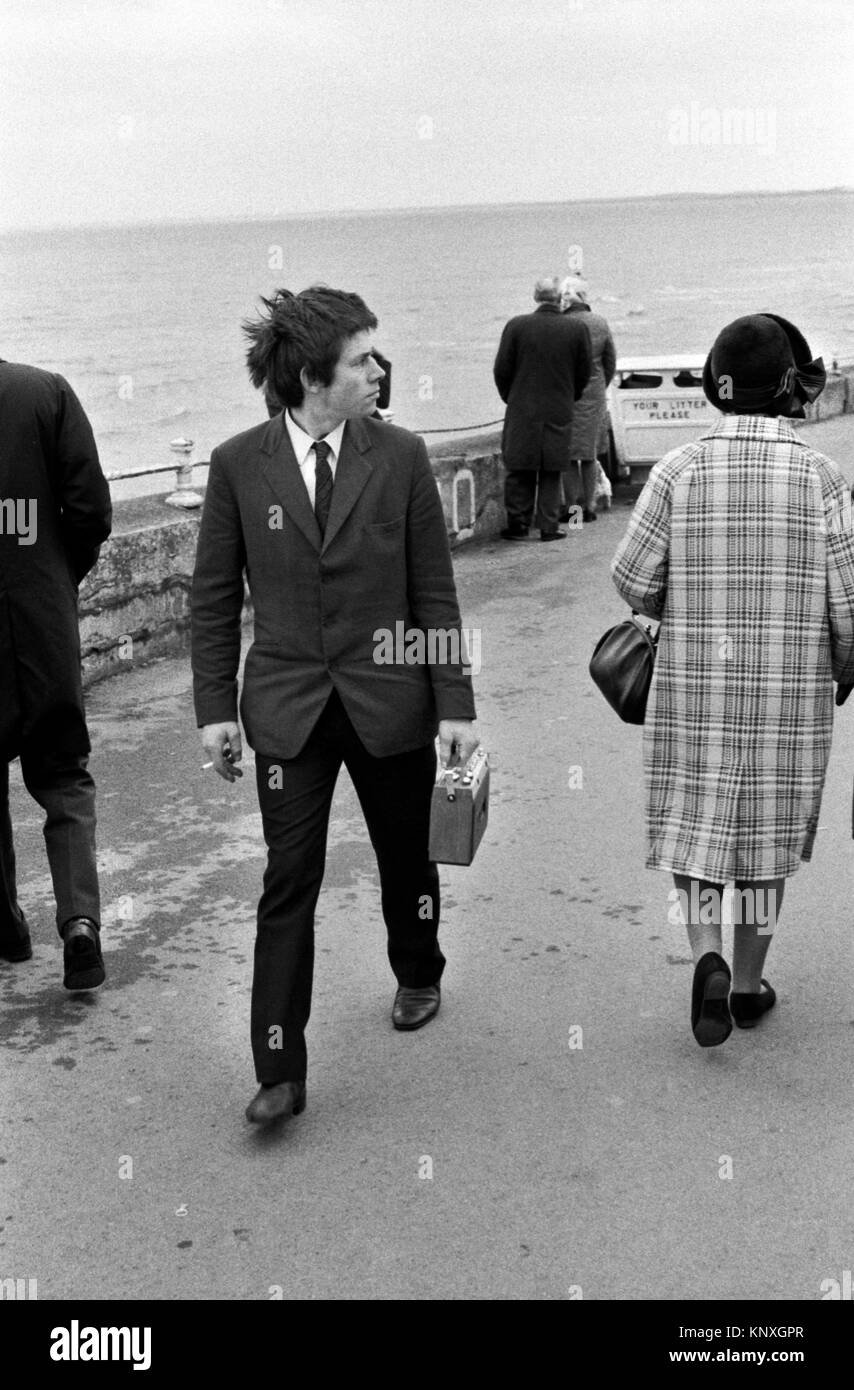 Old fashioned retro transistor radio, young adult carrying the wireless ...