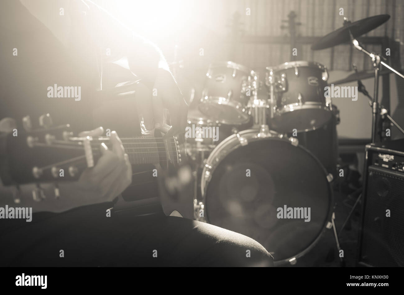 Closeup musician playing the guitar on band background with spot light ...