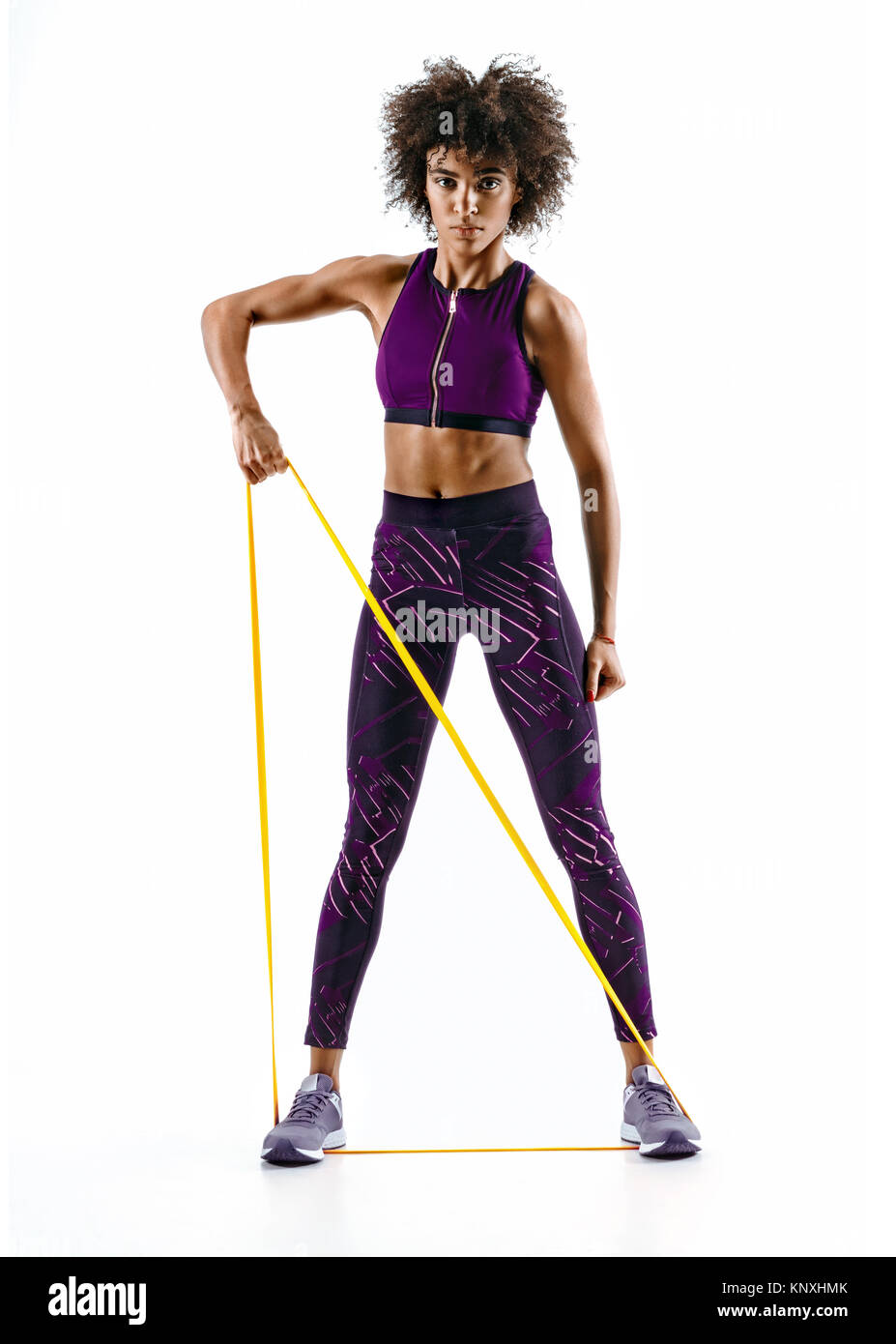Athletic girl performs exercises using a resistance band. Photo of ...