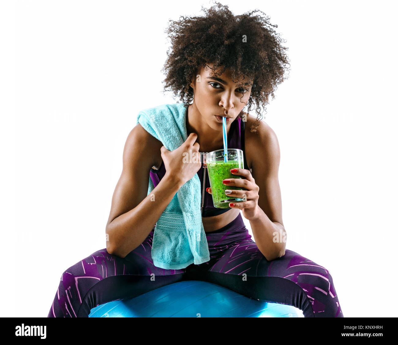 Break time. Beautiful girl with towel and glass of detox cocktail ...