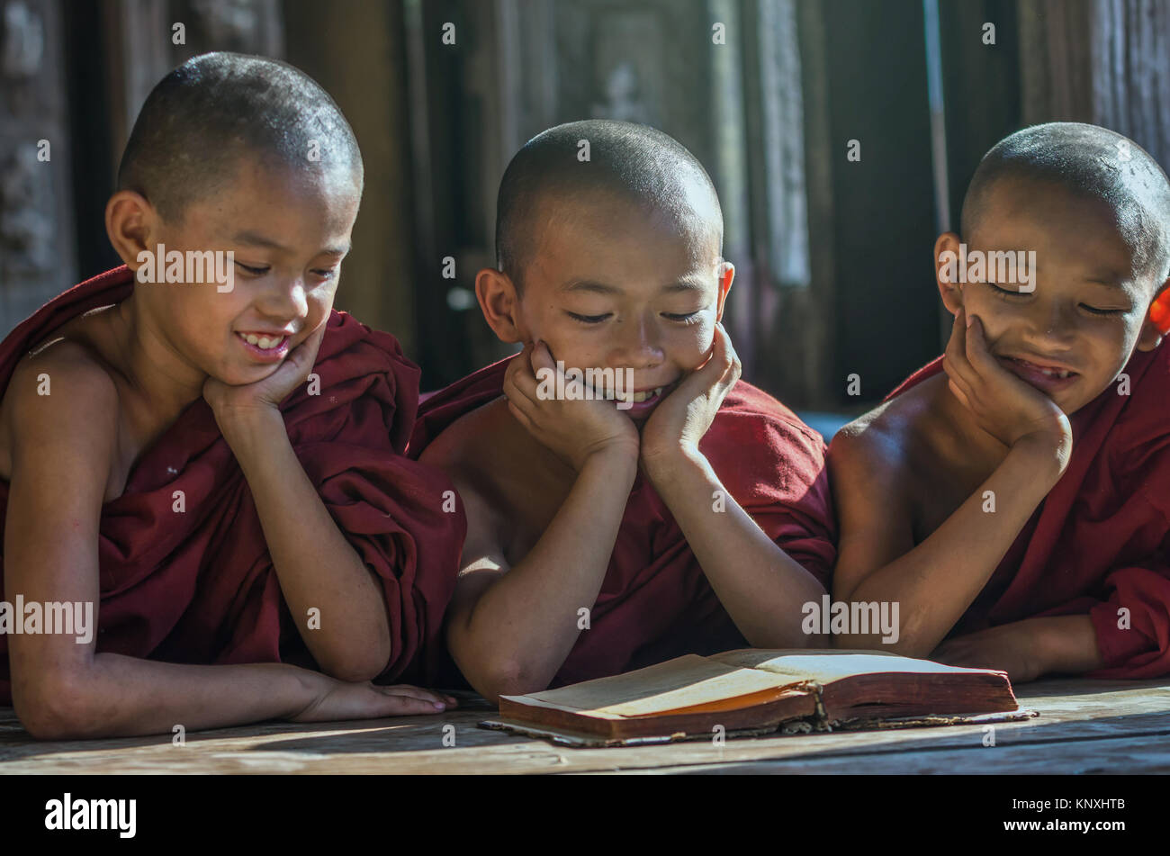 Three Buddhist novice reading at Shwenandaw pagoda, mandalay, myanmar ...