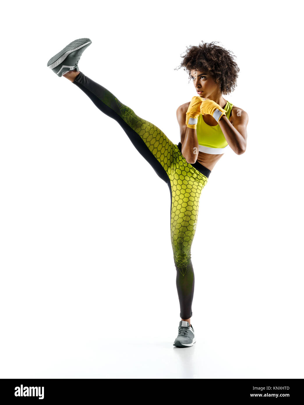 Girl practicing tae-bo exercises, kicking forward with legs. Photo of ...