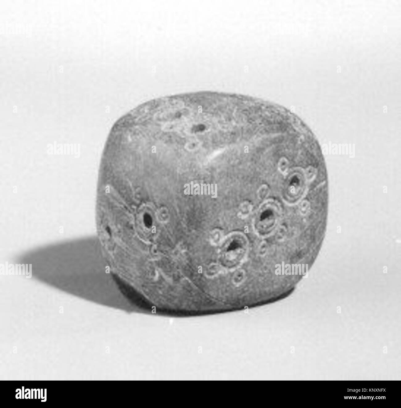 A preserved ivory die in a museum collection, demonstrating medieval ...