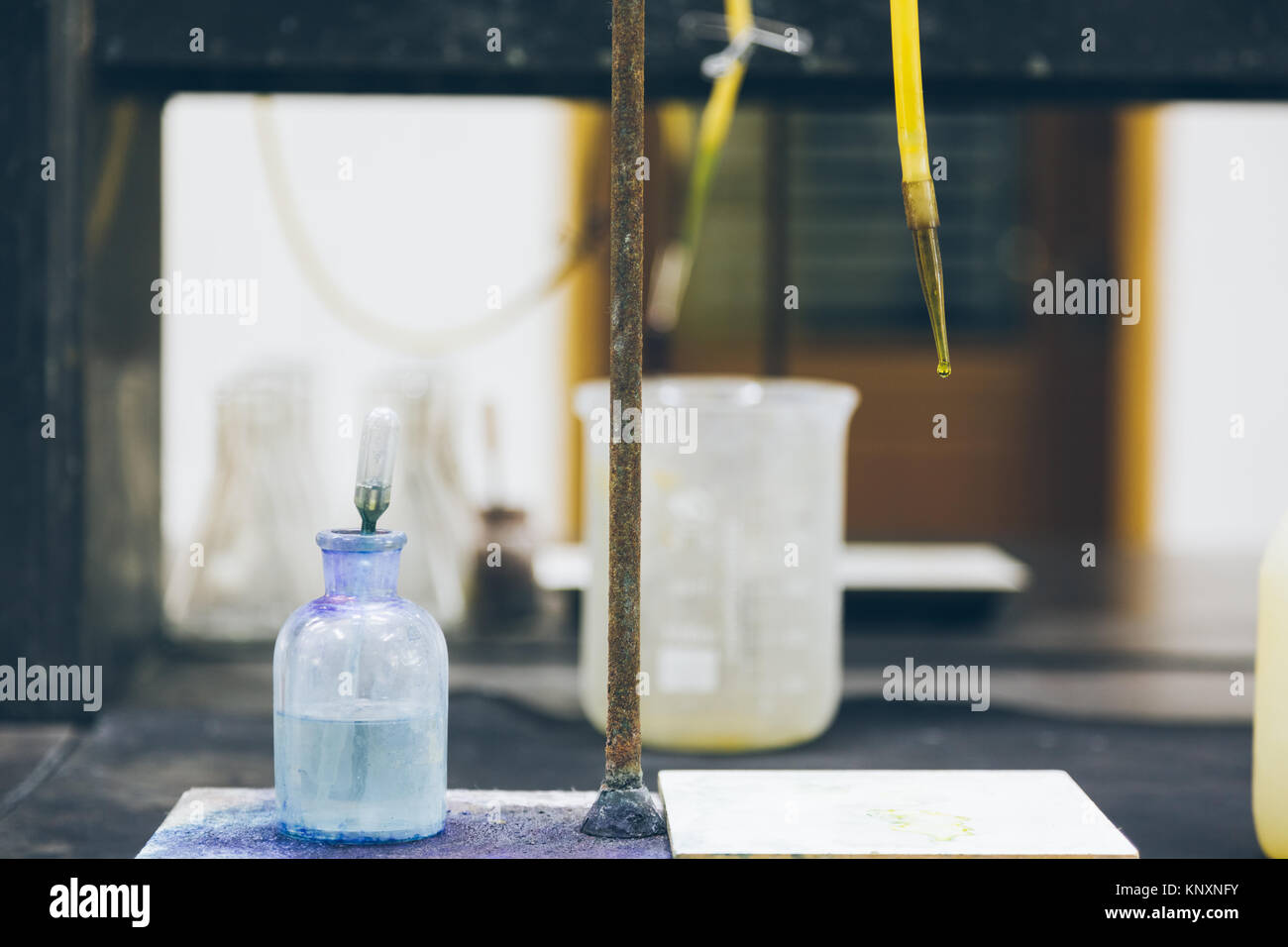 detail shot of beakers and equipment on table in factory laboratory ...