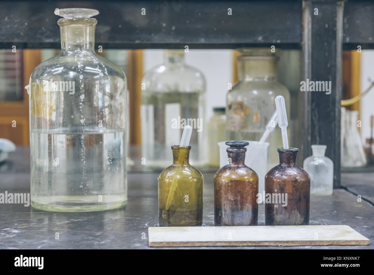 detail shot of beakers and equipment on table in factory laboratory ...