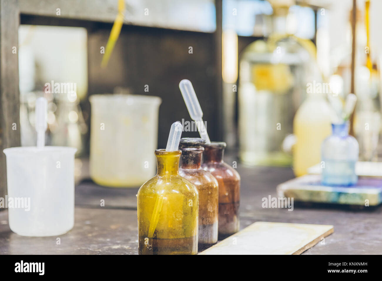 detail shot of beakers and equipment on table in factory laboratory ...
