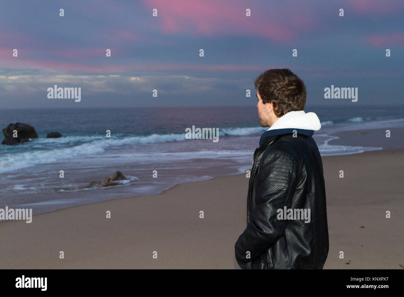 Young man looking at the sea Stock Photo - Alamy