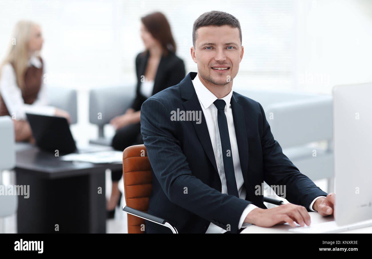 portrait of a successful businessman sitting behind a Desk Stock Photo ...