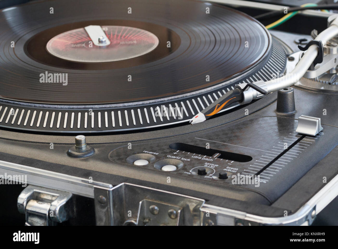 The dj uses vinyl records to mix electronic music and beat rap sound ...