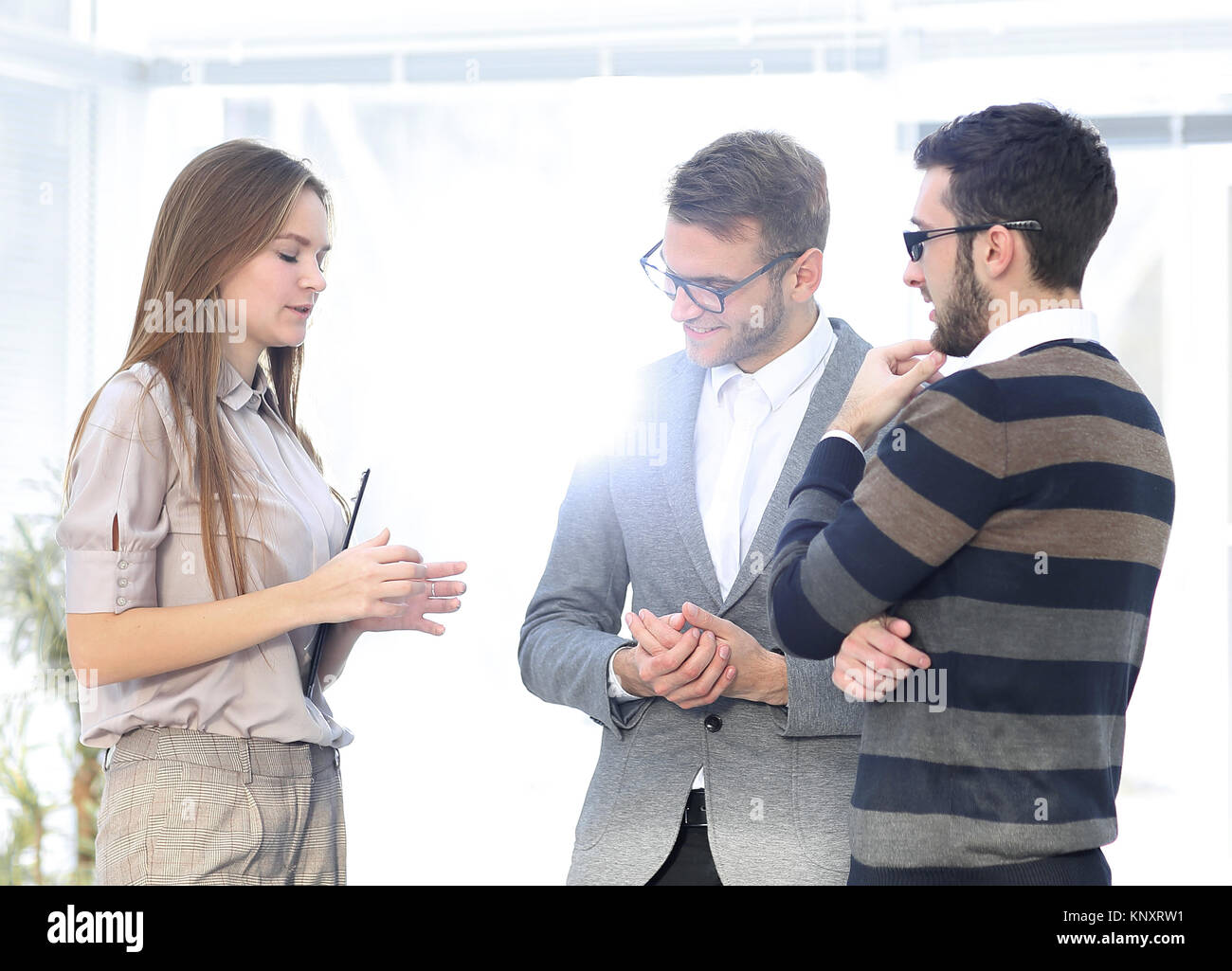 employees discussing working paper Stock Photo - Alamy