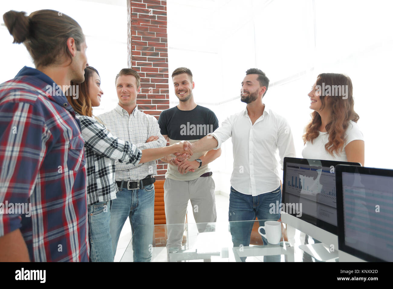 handshake partners in the creative office Stock Photo - Alamy