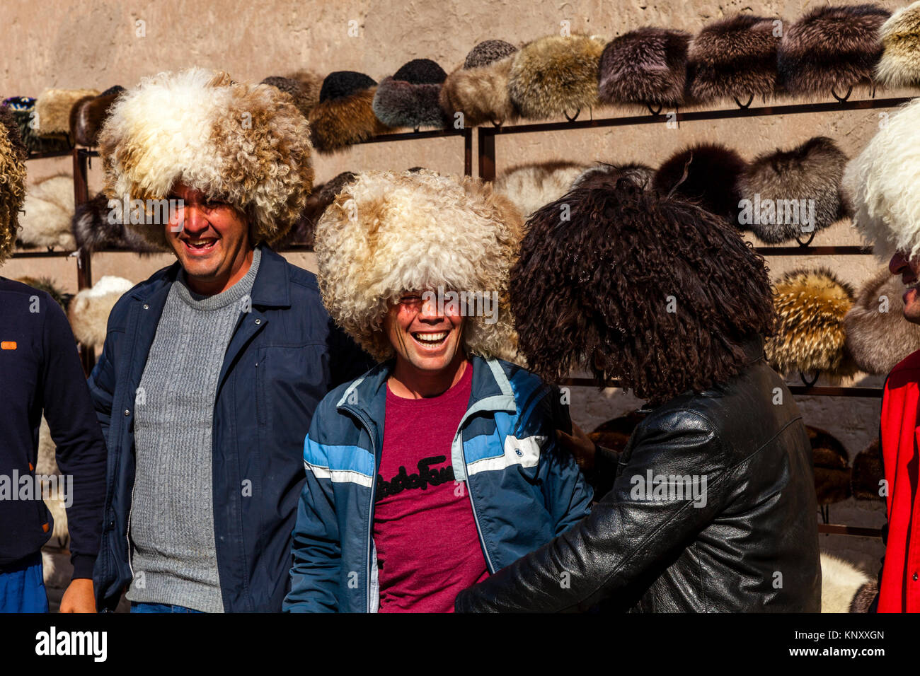 A Group Of Uzbek Tourists Laugh As They Try On Traditional Woollen Hats ...