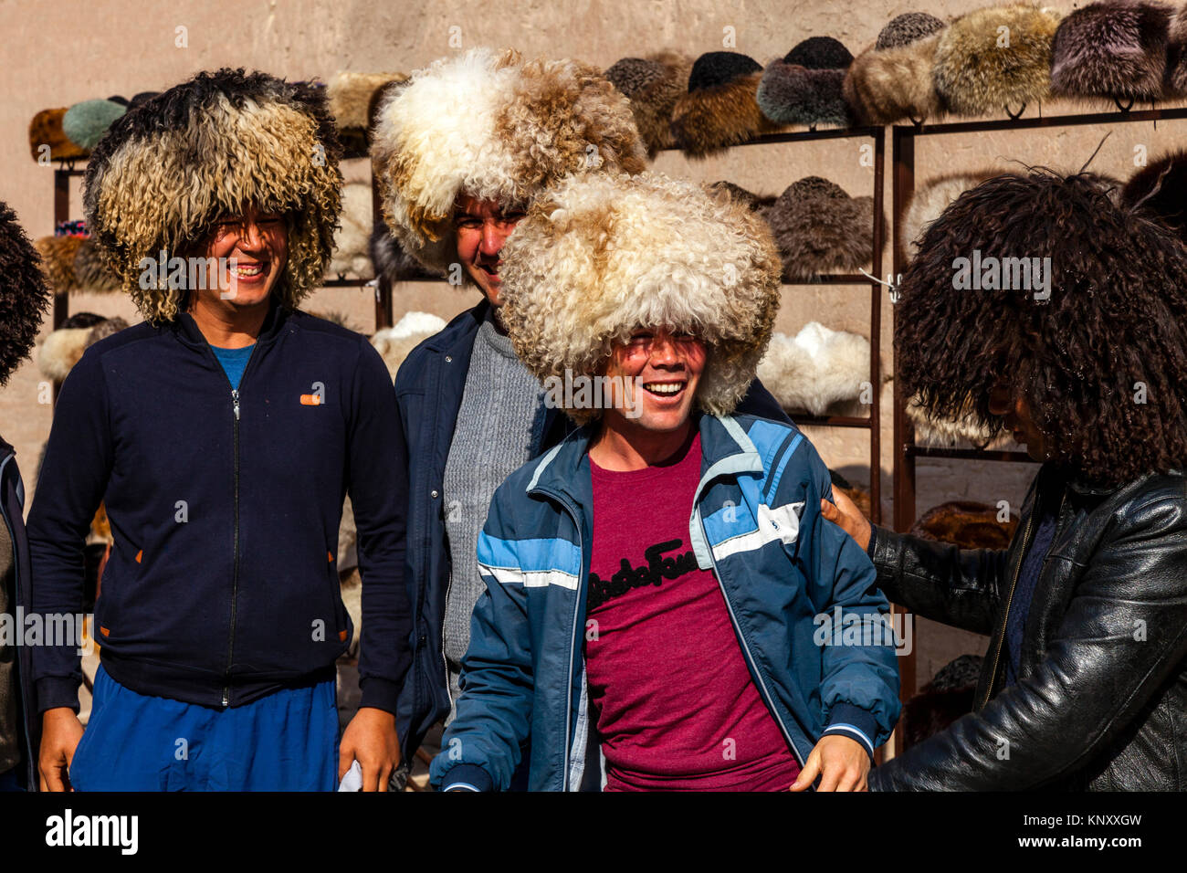 A Group Of Uzbek Tourists Laugh As They Try On Traditional Woollen Hats ...