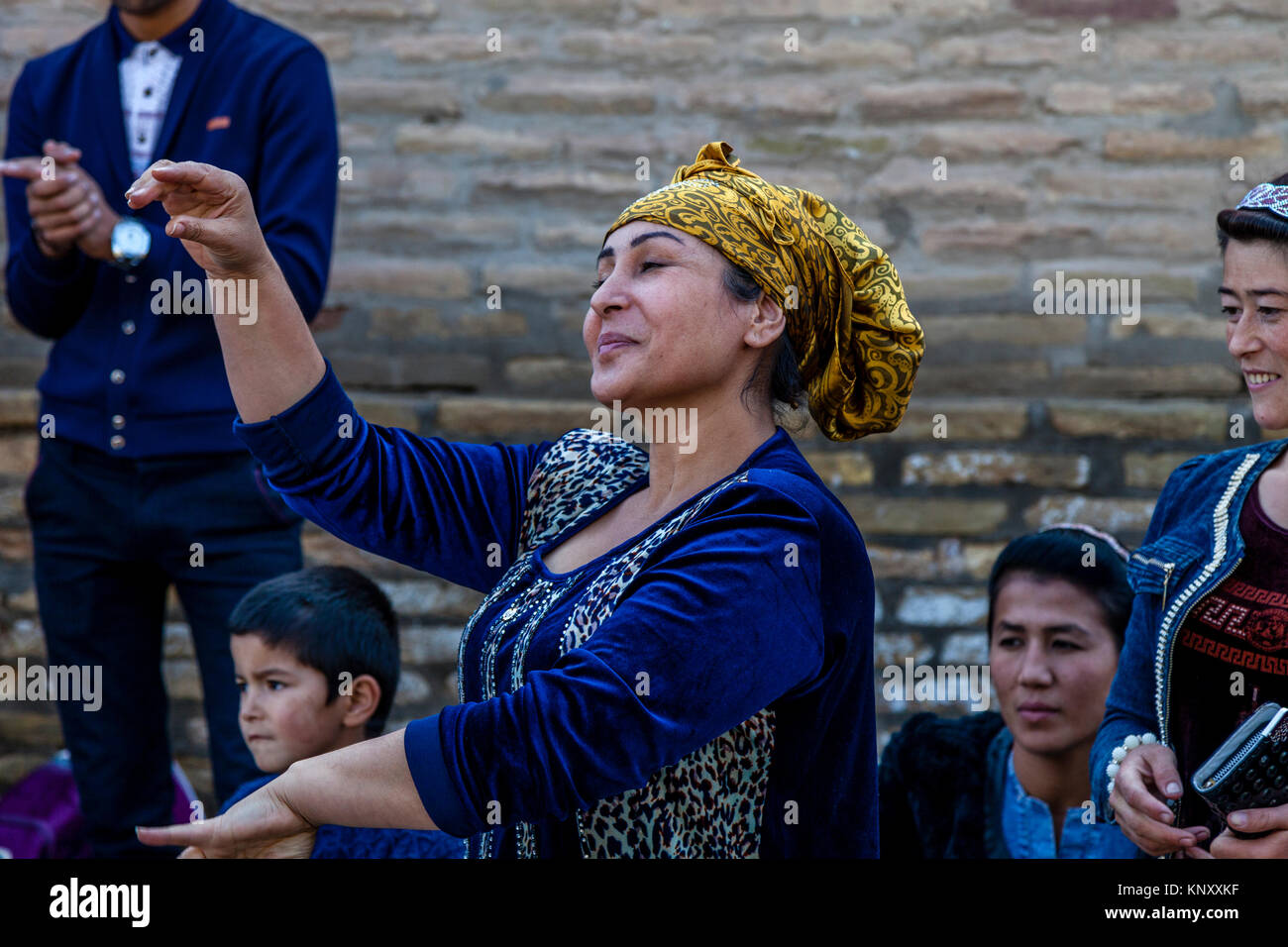 An Uzbek Woman Dancing In The Street, Khiva, Uzbekistan Stock Photo - Alamy