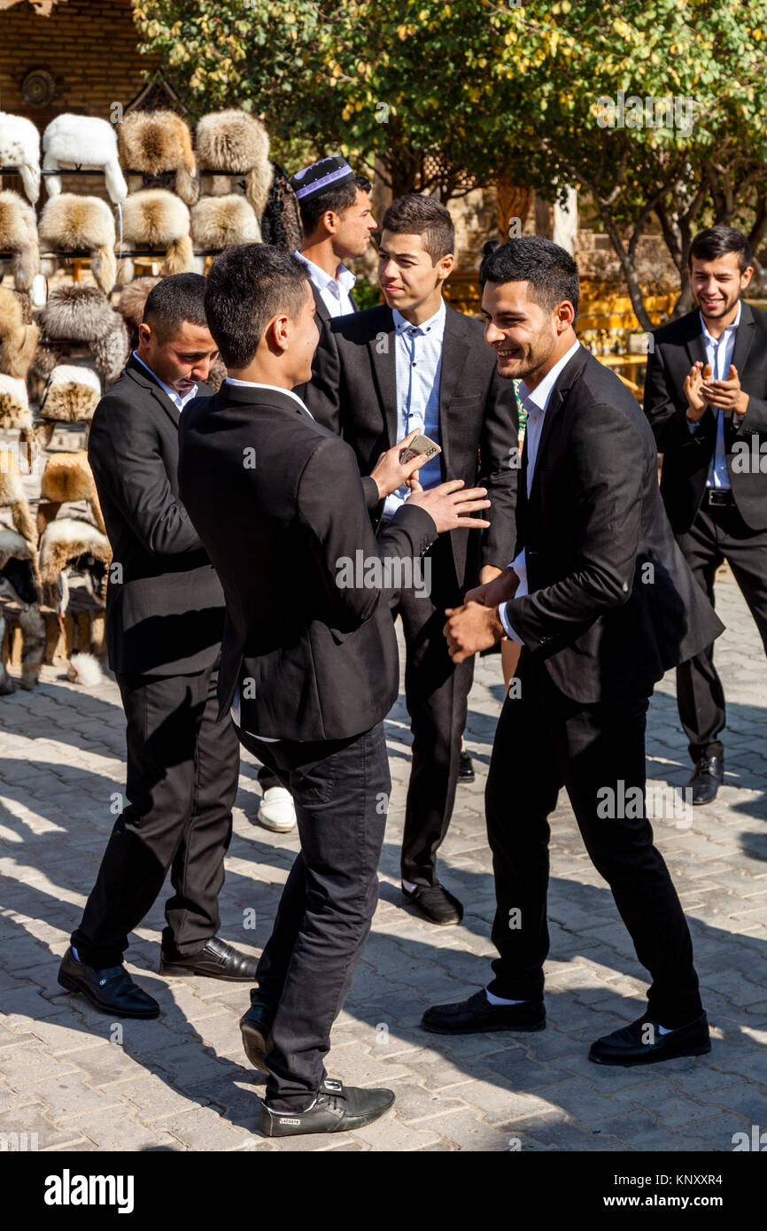 Wedding Guests Dance In The Street During Wedding Celebrations, Khiva ...