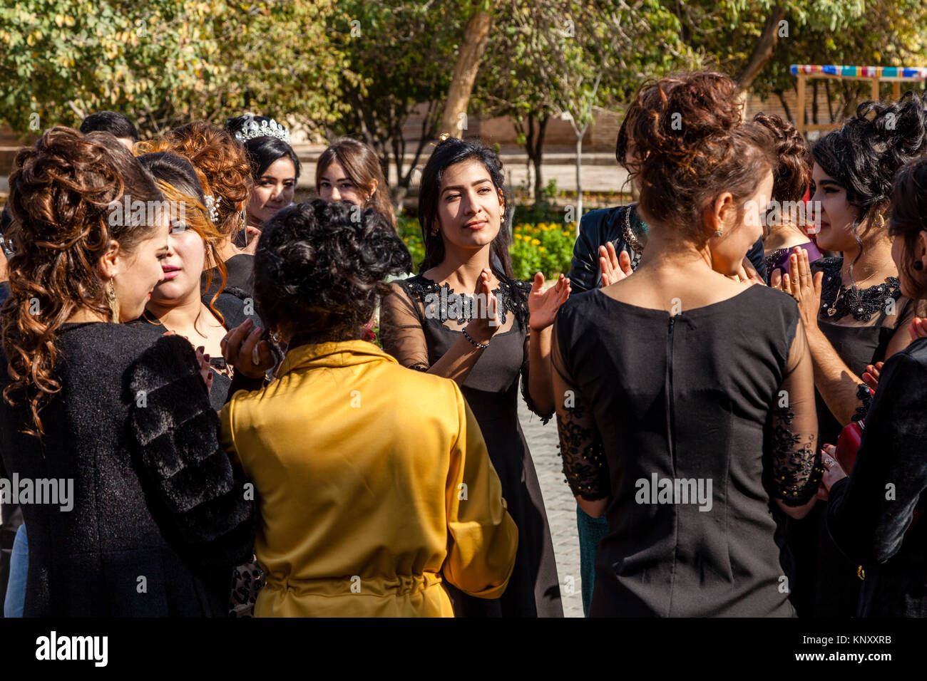Female Wedding Guests Dance In The Street During Wedding Celebrations ...