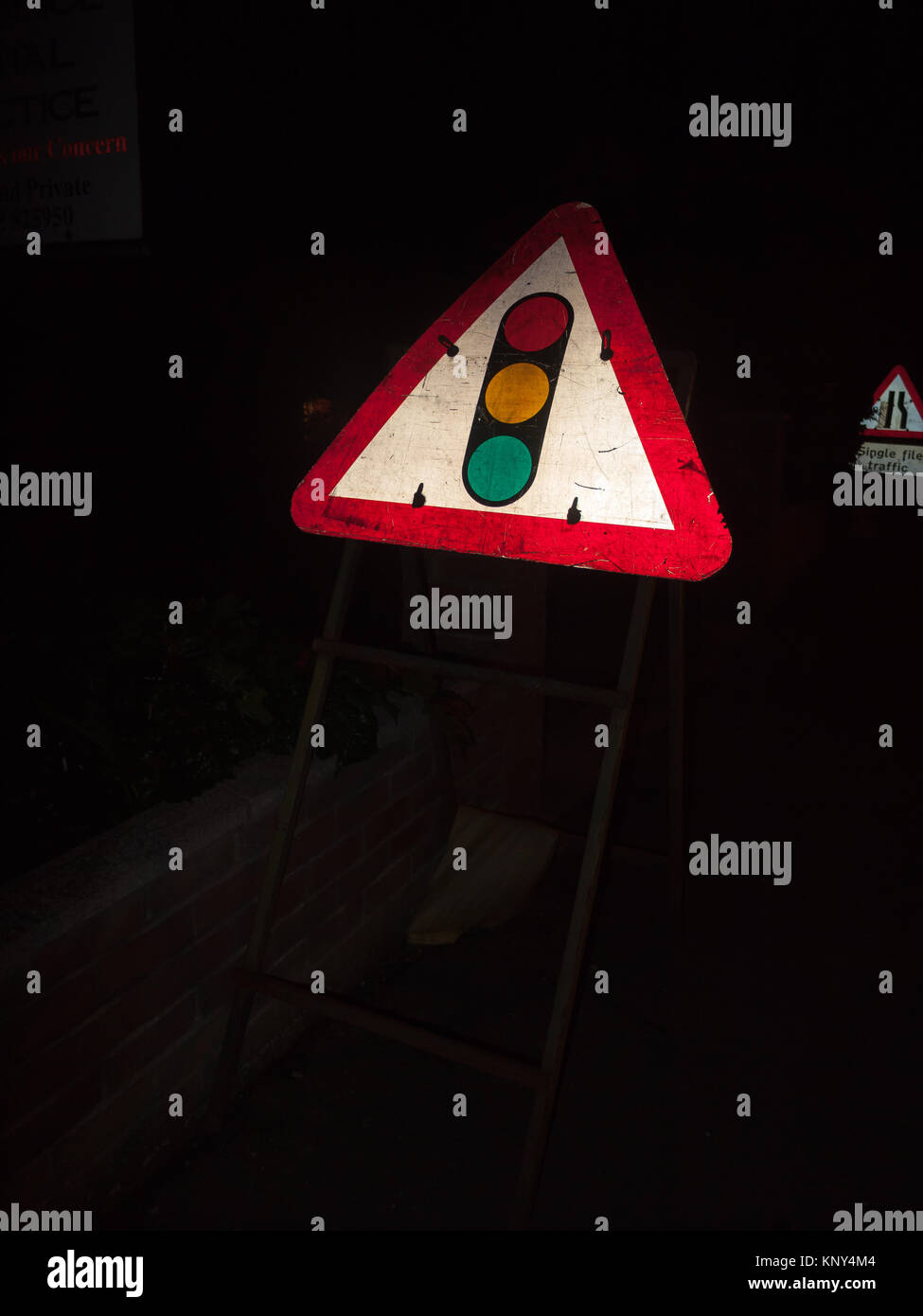 traffic light sign at night triangle red amber green construction ...