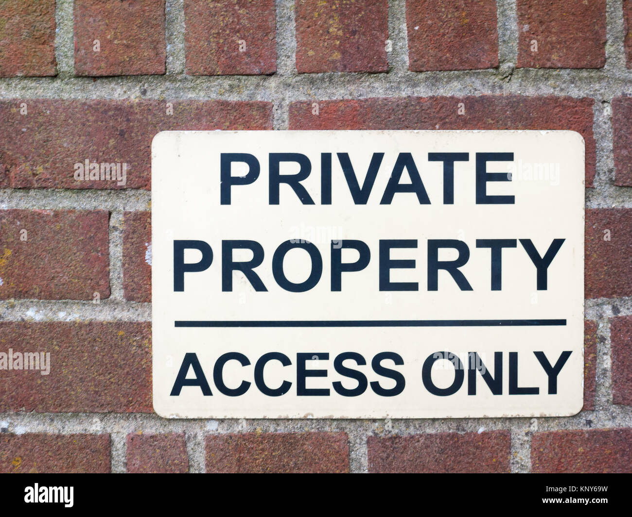 private property access only black and white sign on brick wall close ...