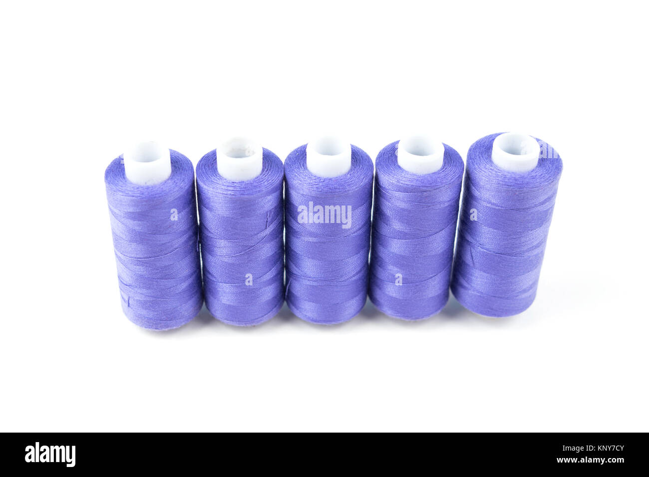 Five purple sewing threads on a white background, sewing and tailoring ...