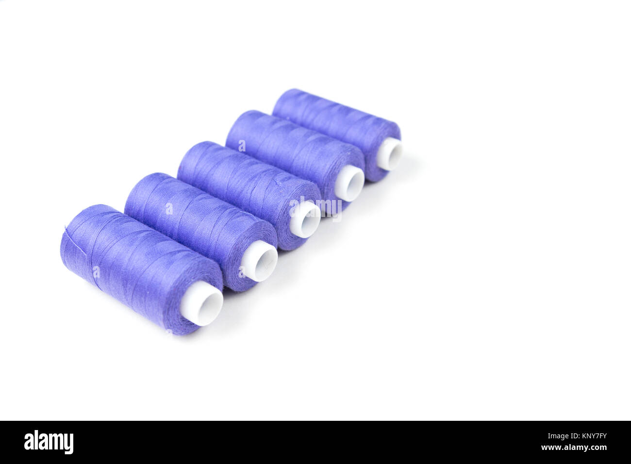 Five purple sewing threads on a white background, sewing and tailoring ...
