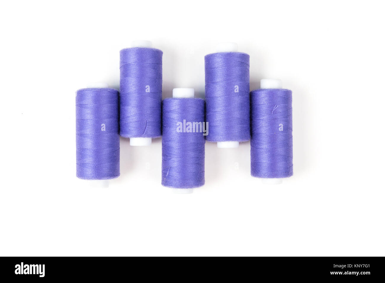Five purple sewing threads on a white background, sewing and tailoring ...