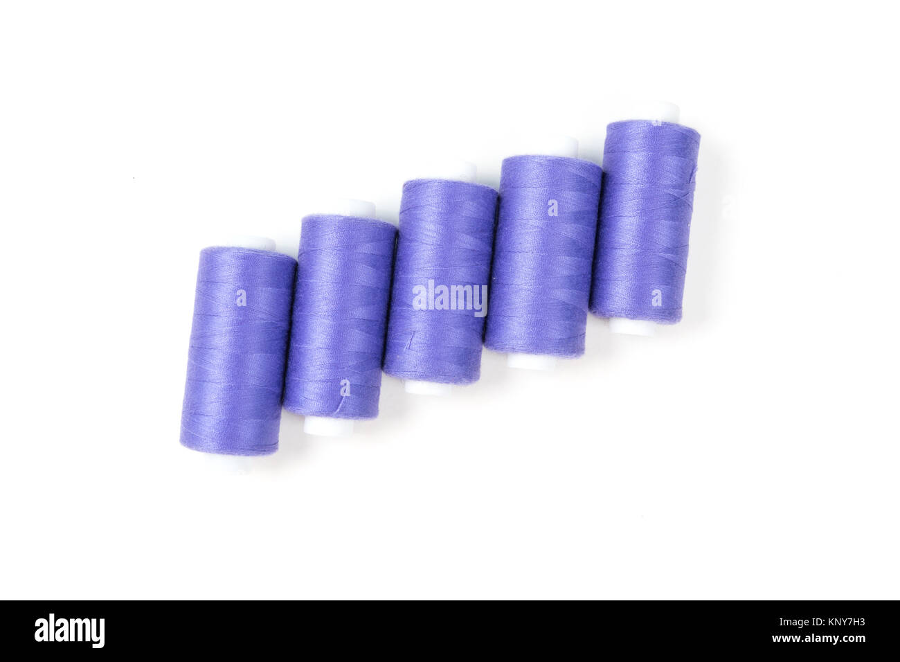Five purple sewing threads on a white background, sewing and tailoring ...