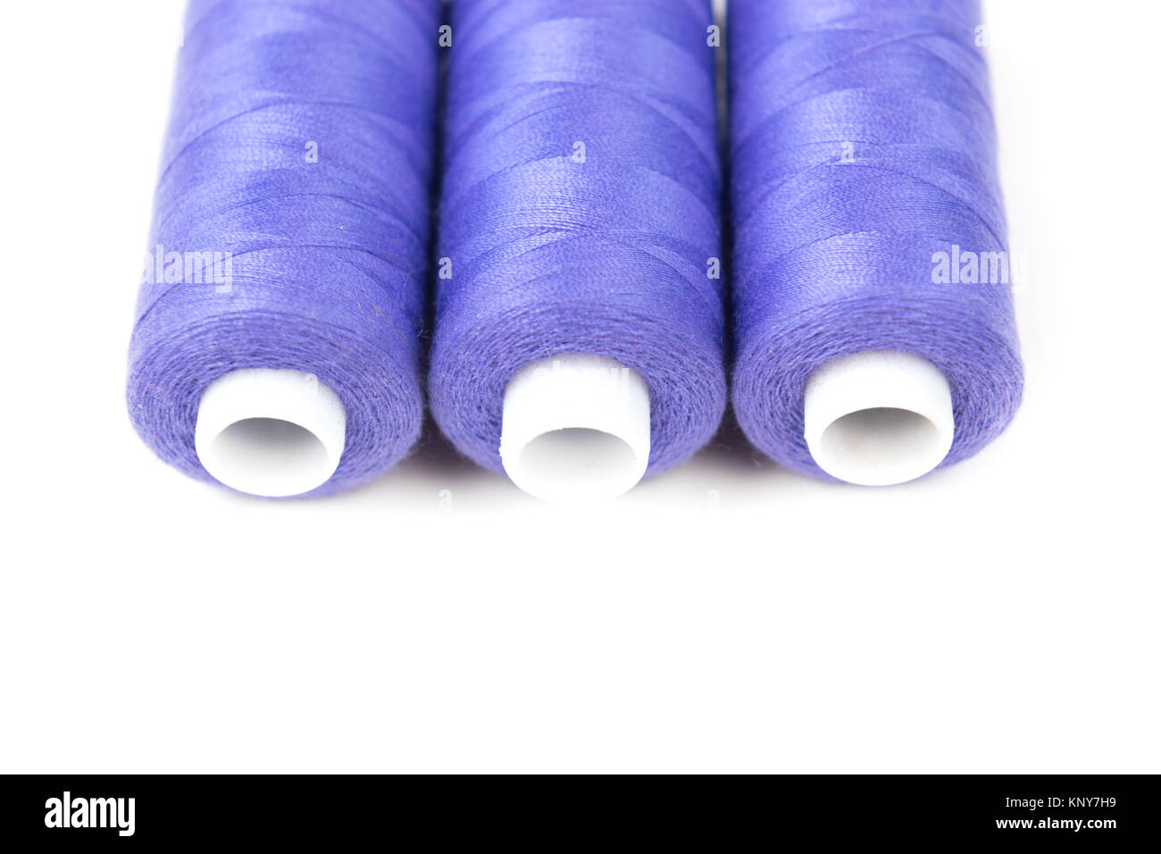 Three purple sewing threads on a white background, sewing accessories ...