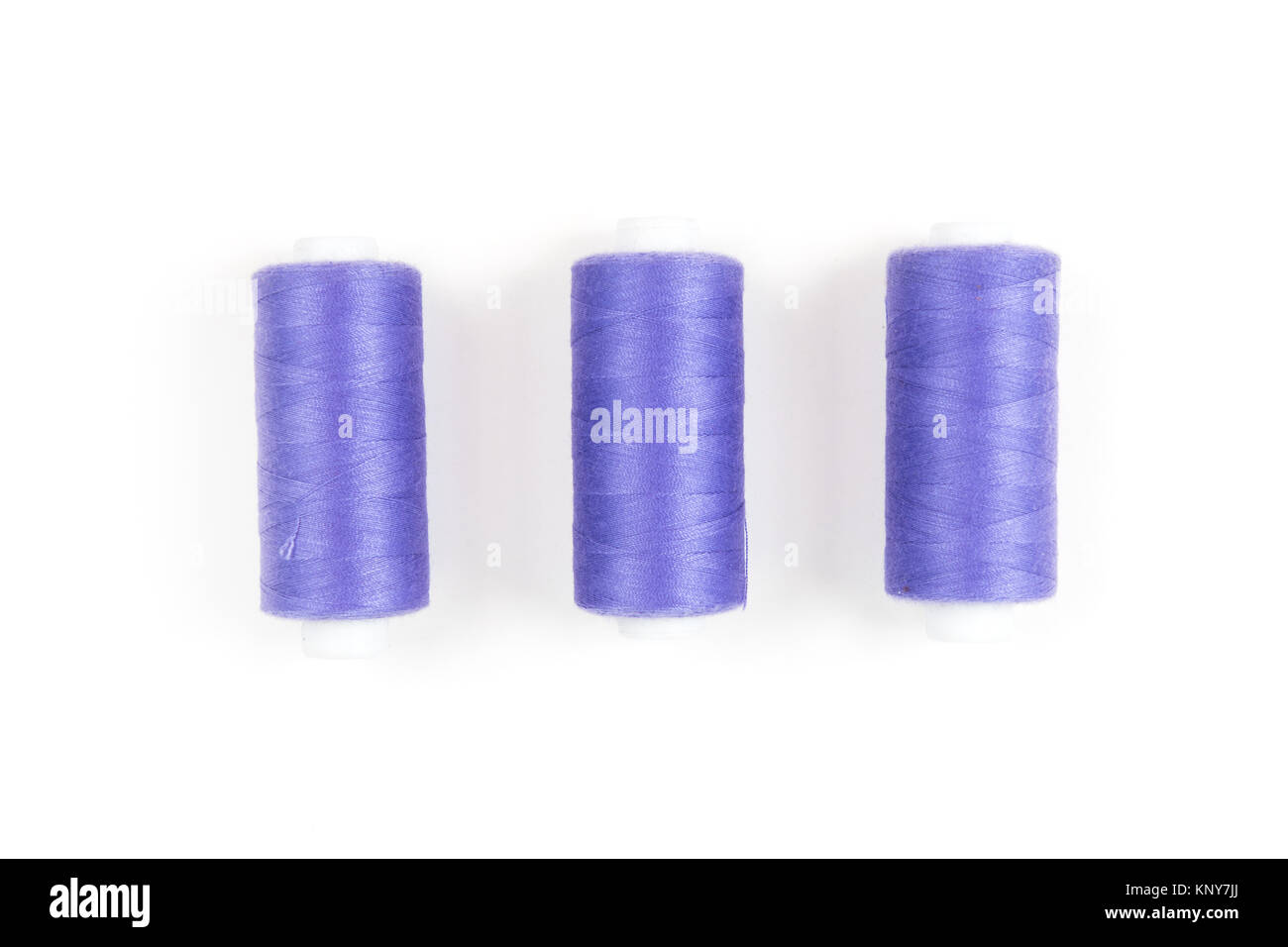 Three separated purple sewing threads on a white background Stock Photo ...