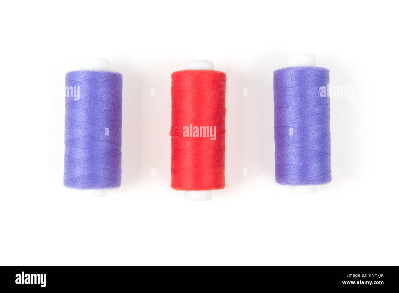 Red and purple sewing threads on a white background. Set of three ...
