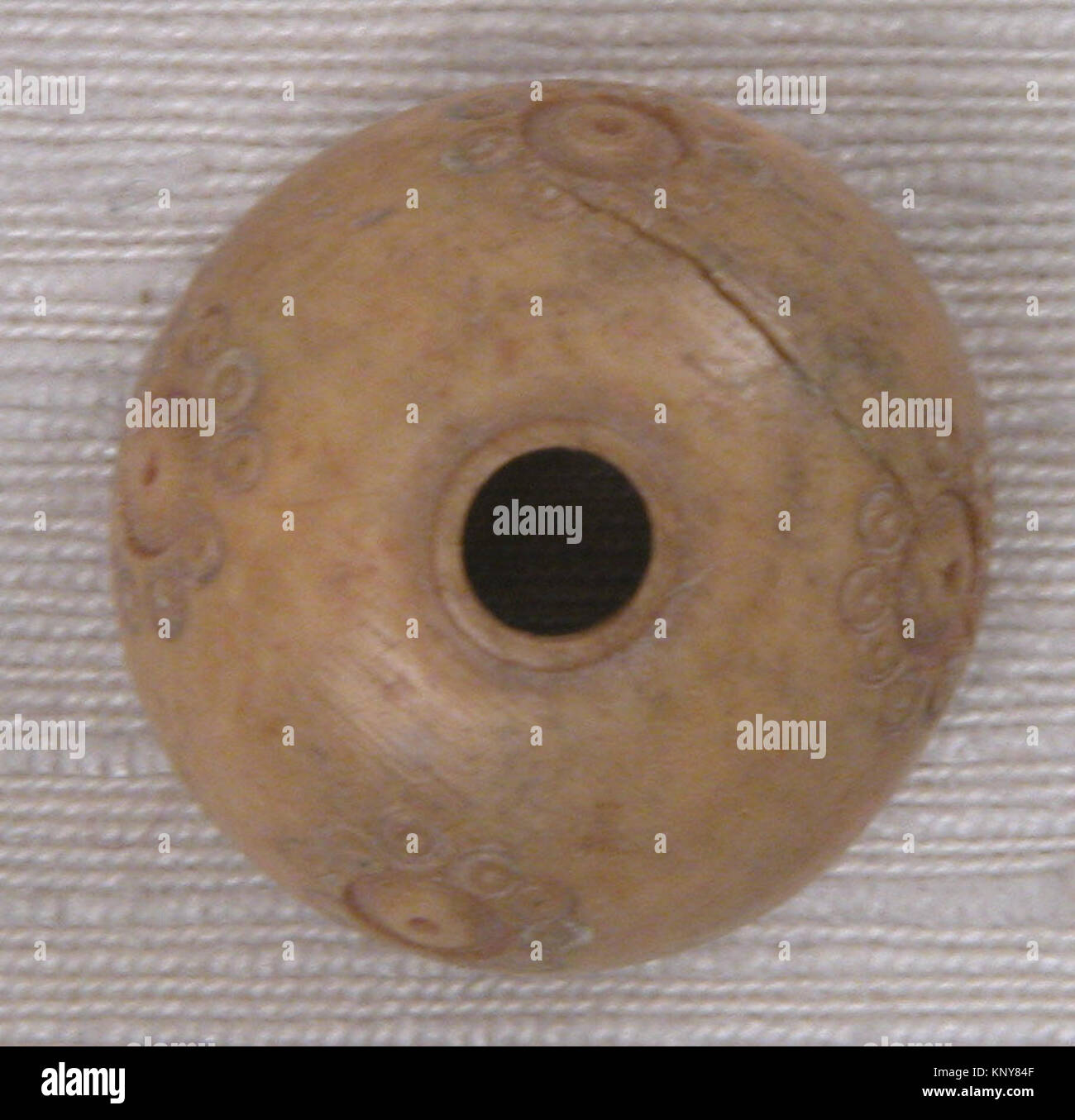 A museum-recorded button or spindle whorl catalogued as MET sf38-40-56a ...