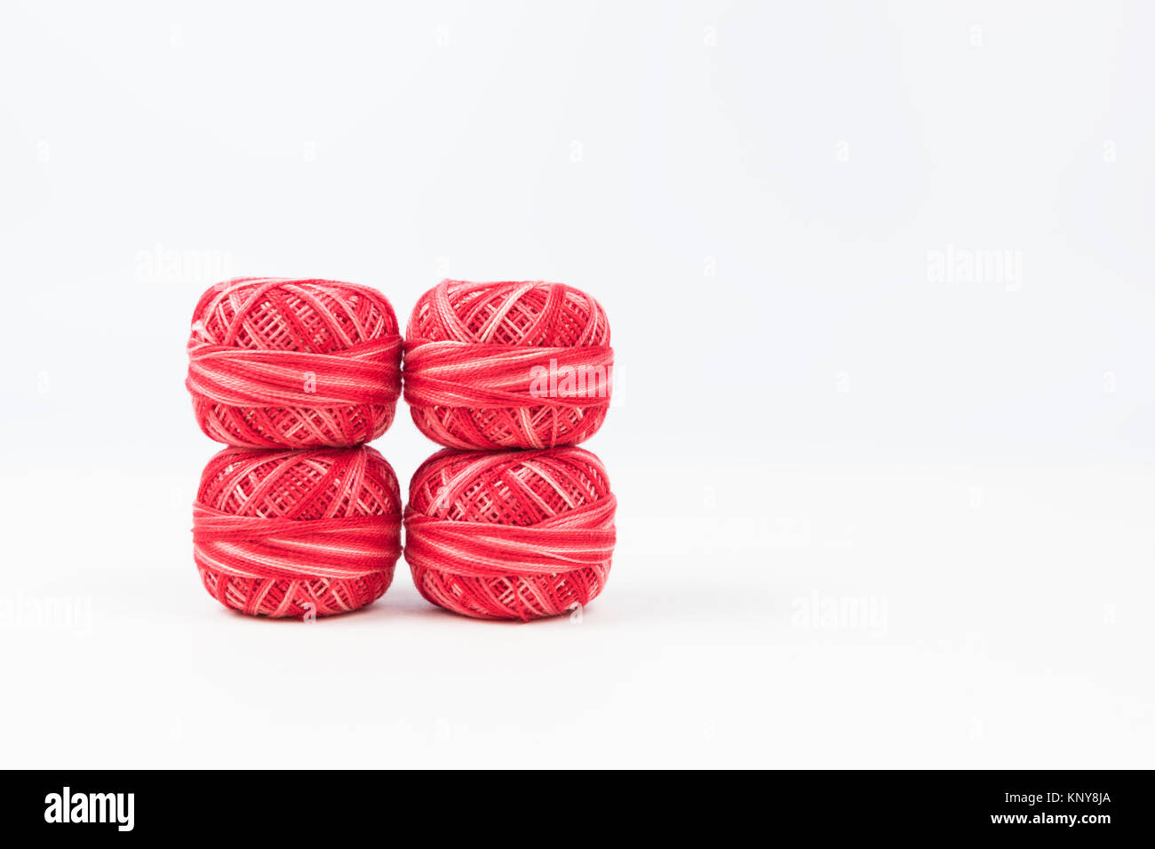 Four red sewing threads Stock Photo - Alamy