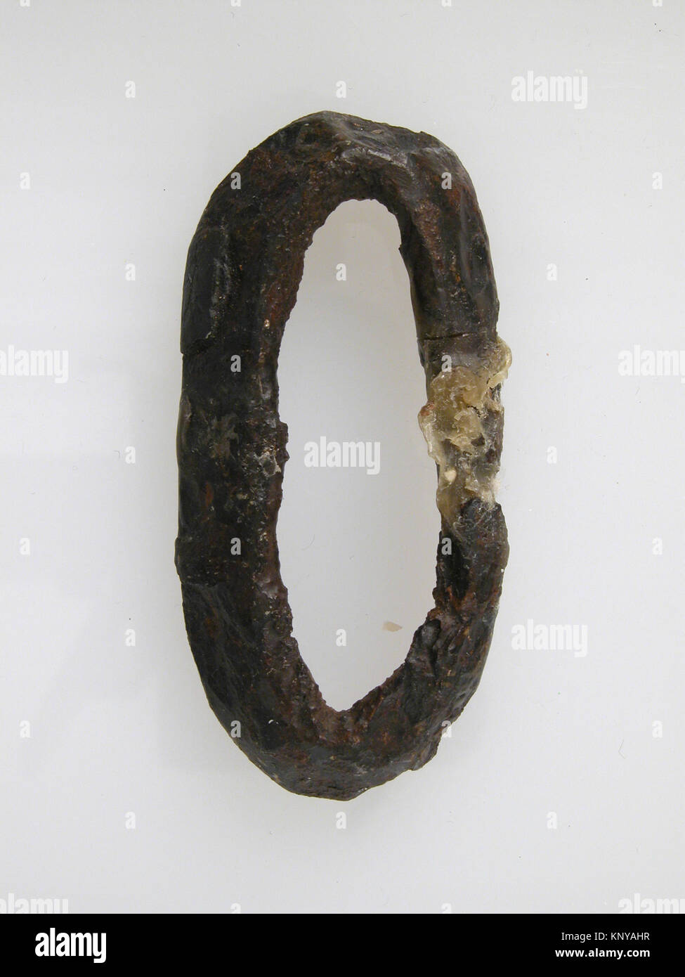 This belt buckle loop is a small metal artifact used for fastening ...