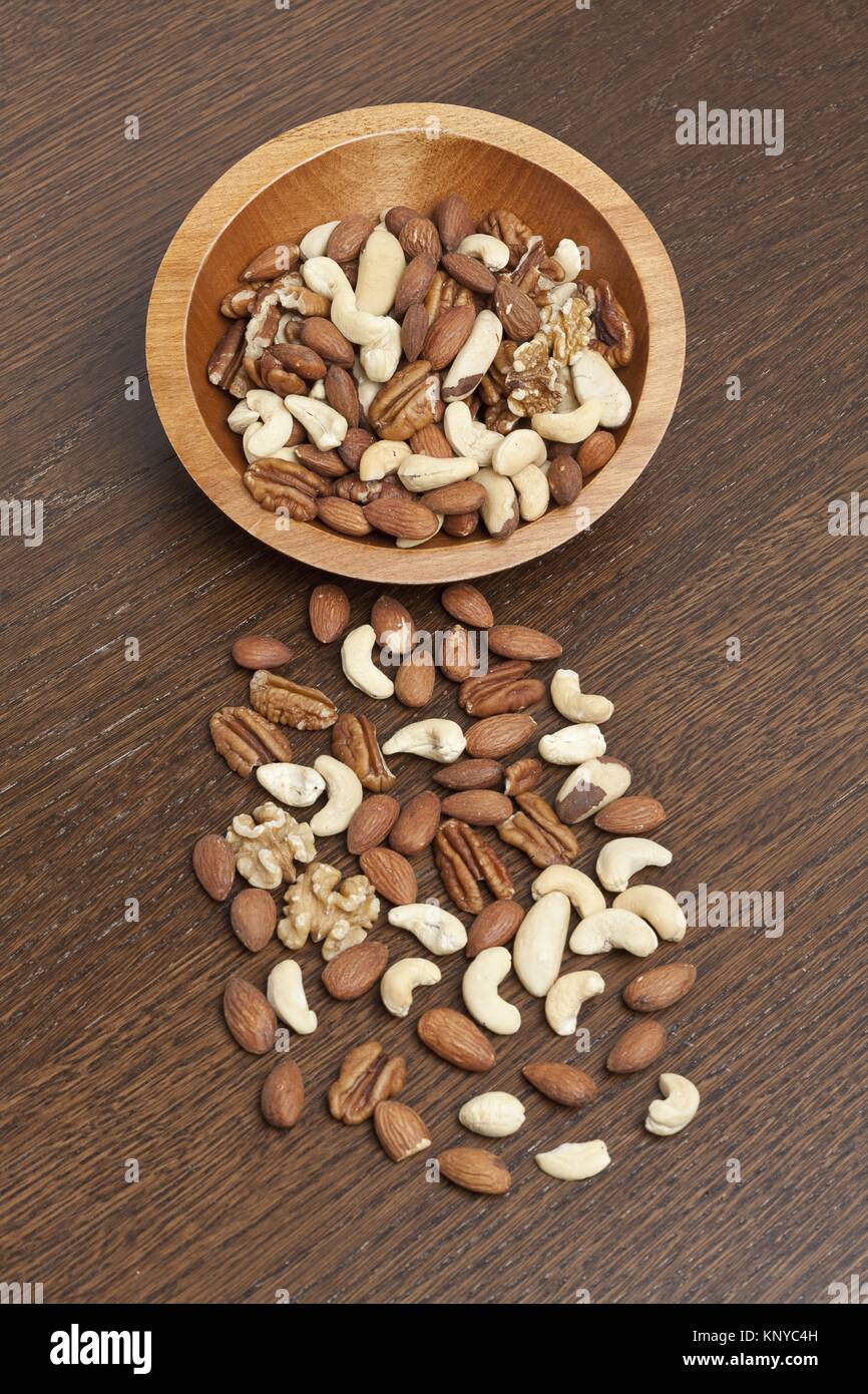 a bowl with spilled mixed nuts Stock Photo - Alamy