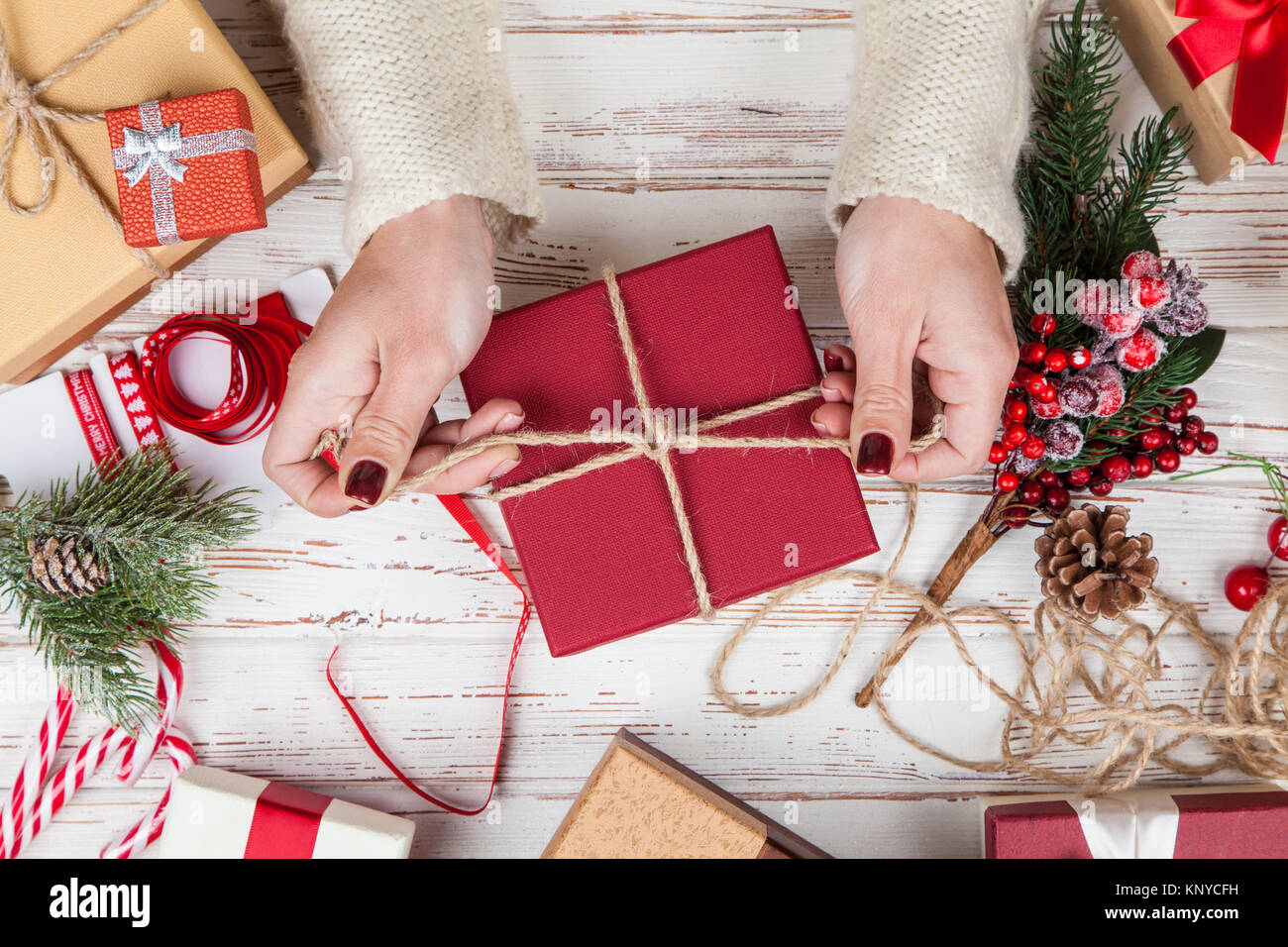 Woman wrapping a present box Stock Photo - Alamy