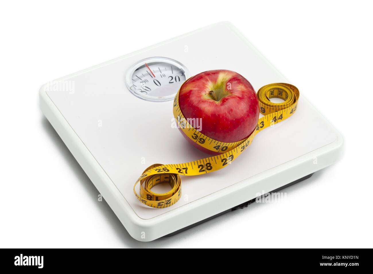 apple tied with tape measure on weight scale Stock Photo - Alamy