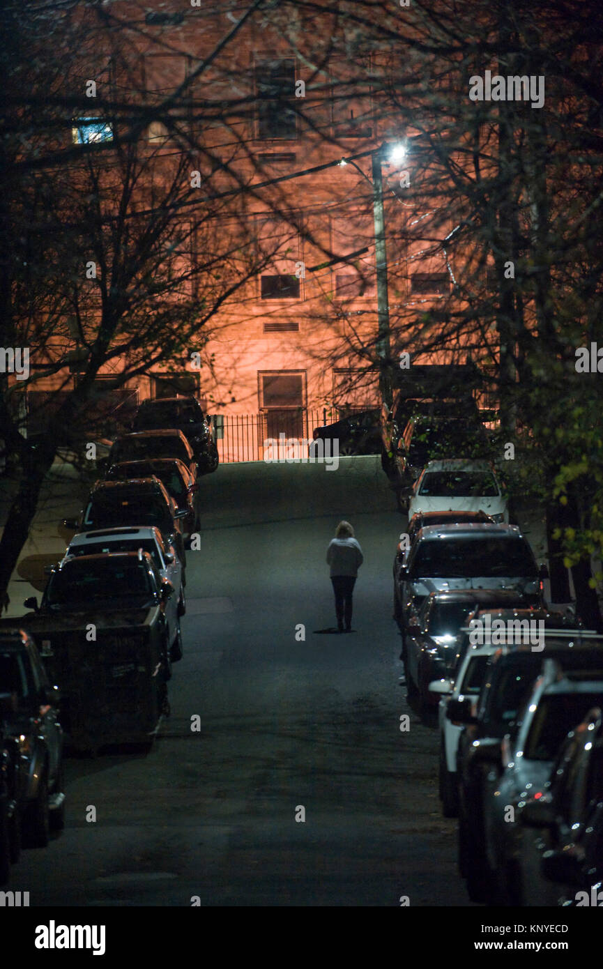 A woman walks alone towards Dorchester Heights in South Boston Stock ...