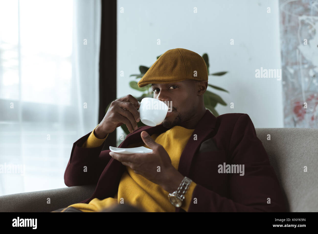 stylish african american man drinking coffee Stock Photo - Alamy