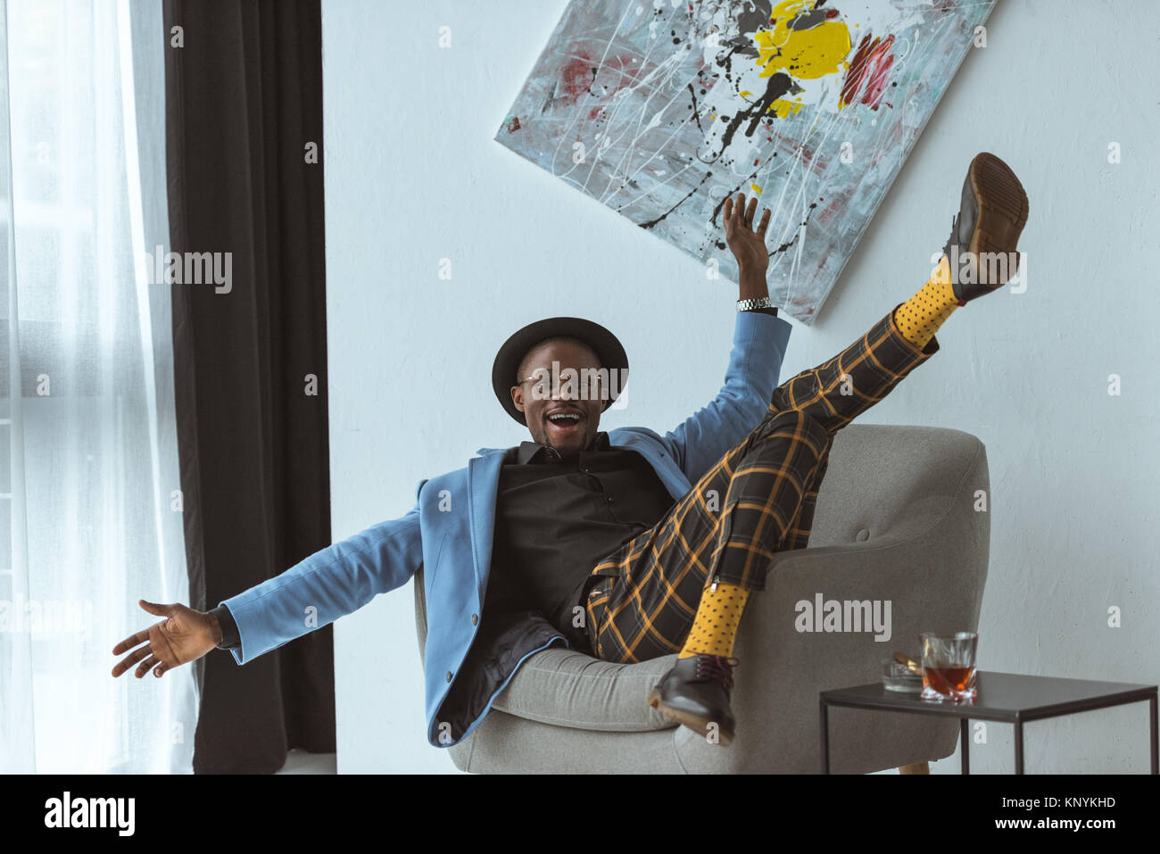 man having fun on armchair Stock Photo - Alamy