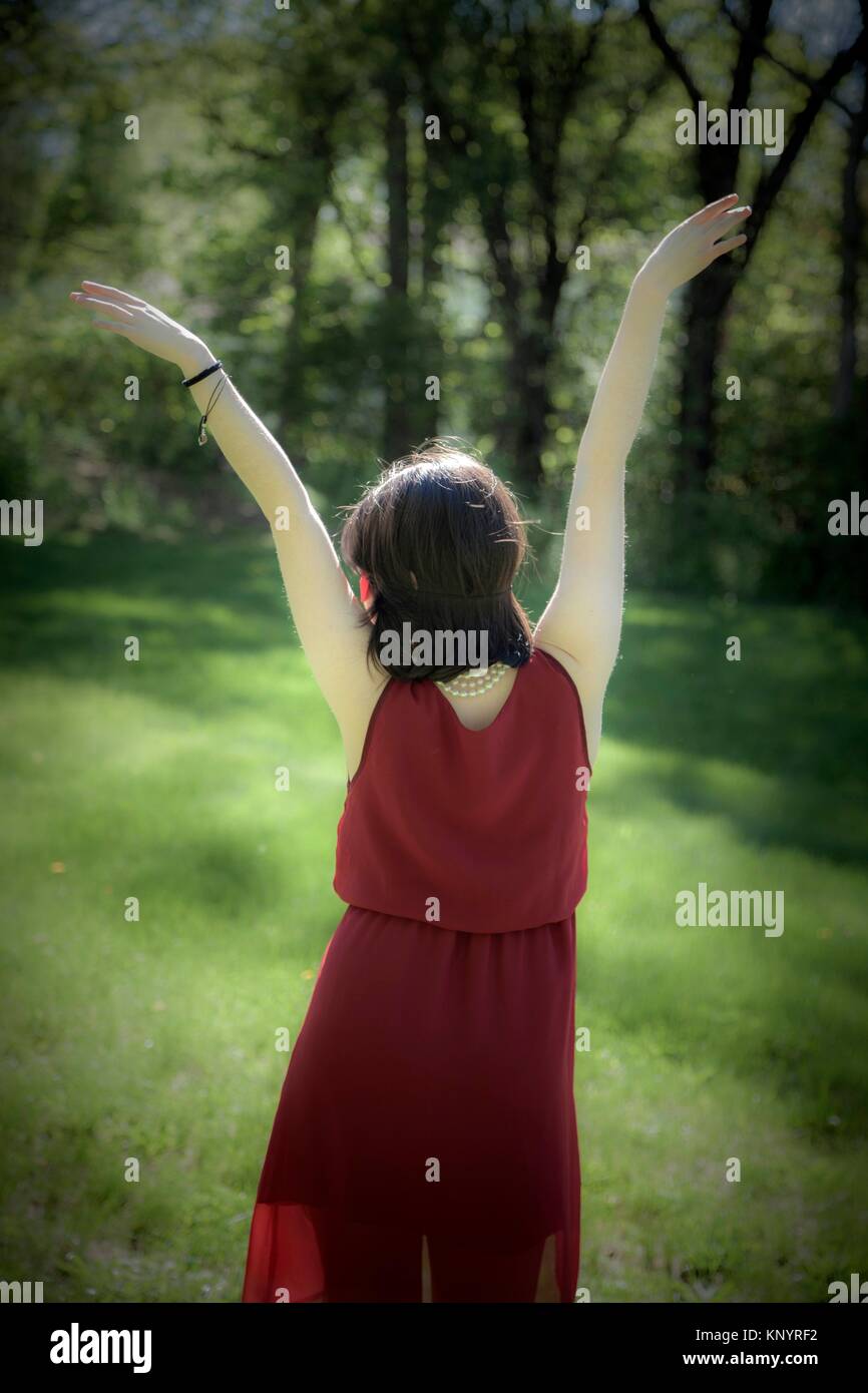 Young woman arms outstretched rear hi-res stock photography and images ...