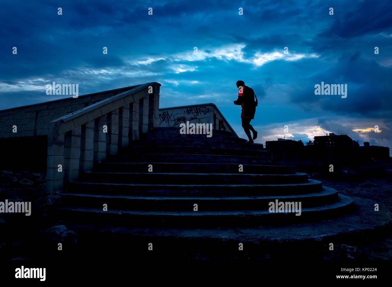 Man running on beach at sunset hi-res stock photography and images - Alamy