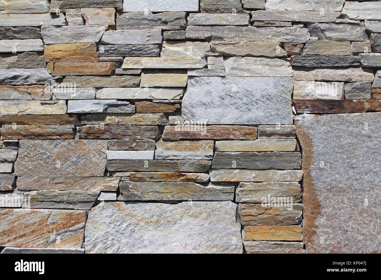 Attractive stone wall comprised of desert quartz bricks of varying ...