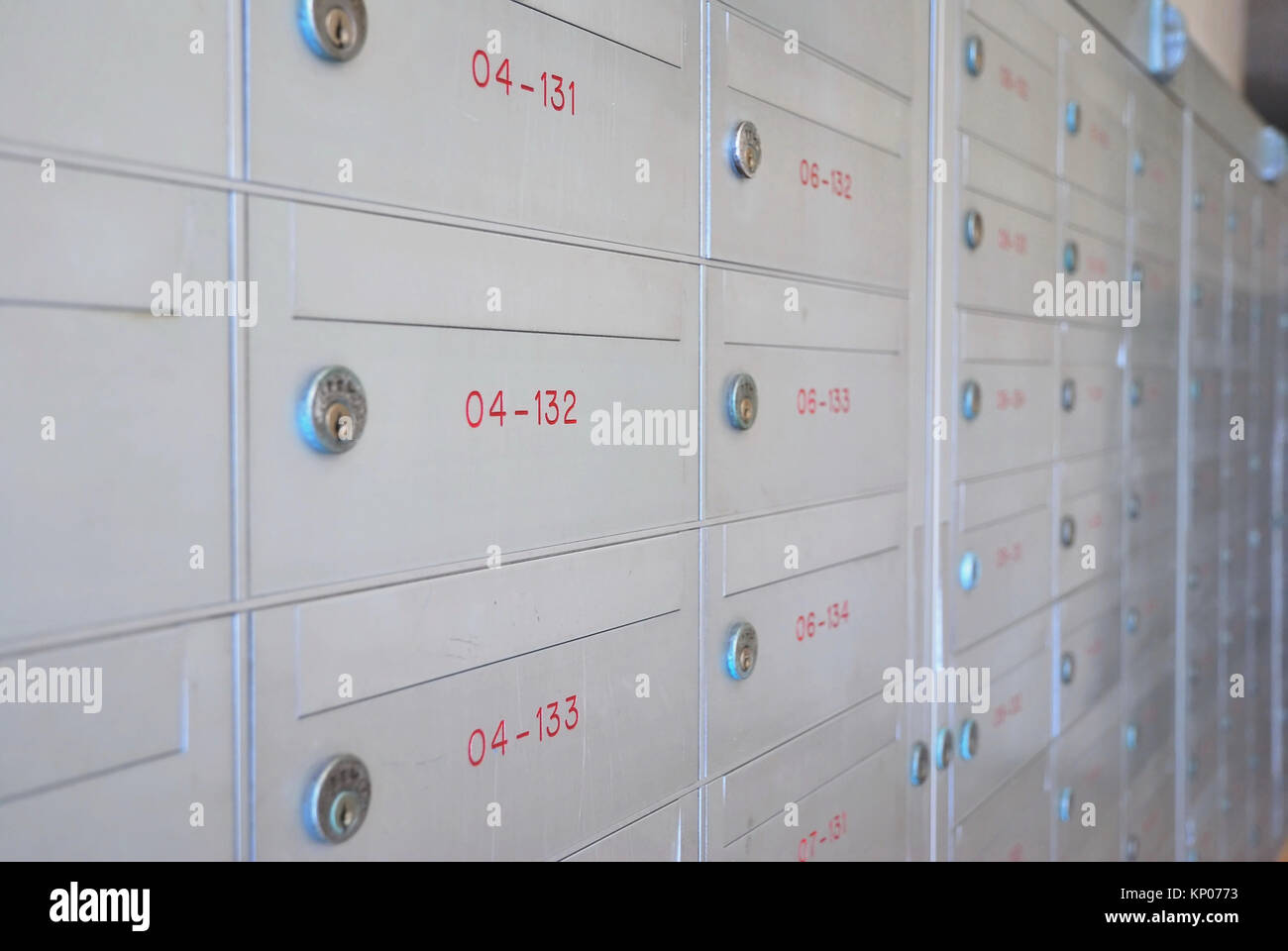 Row of metallic letter boxes with numbers and locks. For concepts such ...