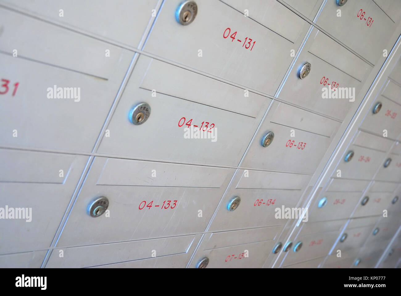 Row of metallic letter boxes with numbers and locks. For concepts such ...