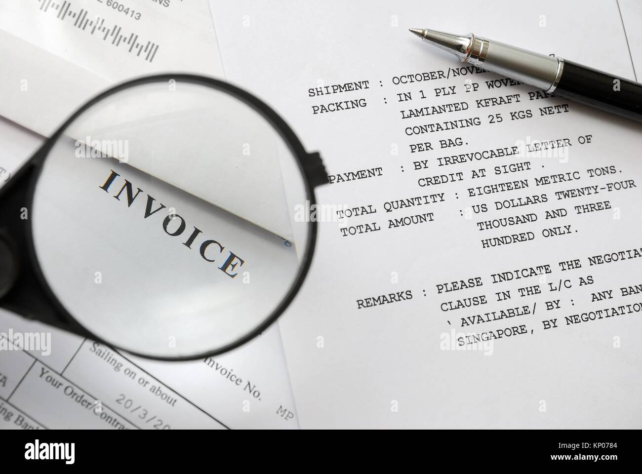 Magnifying Glass On Invoice Text With Pen On Purchase And Sales Related